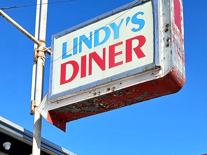 The iconic blue and red Lindy's Diner sign stands as a beacon of comfort food against the New Hampshire sky, promising nostalgic flavors and hometown hospitality.