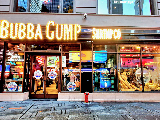 The iconic yellow glow of Bubba Gump's Times Square location beckons like a lighthouse for seafood lovers amid Manhattan's concrete ocean.