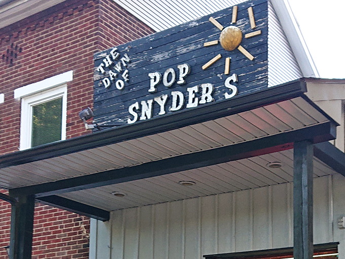 The weathered blue sign with its cheerful sun logo promises something authentic &ndash; a diner that's earned its patina through decades of satisfied customers.