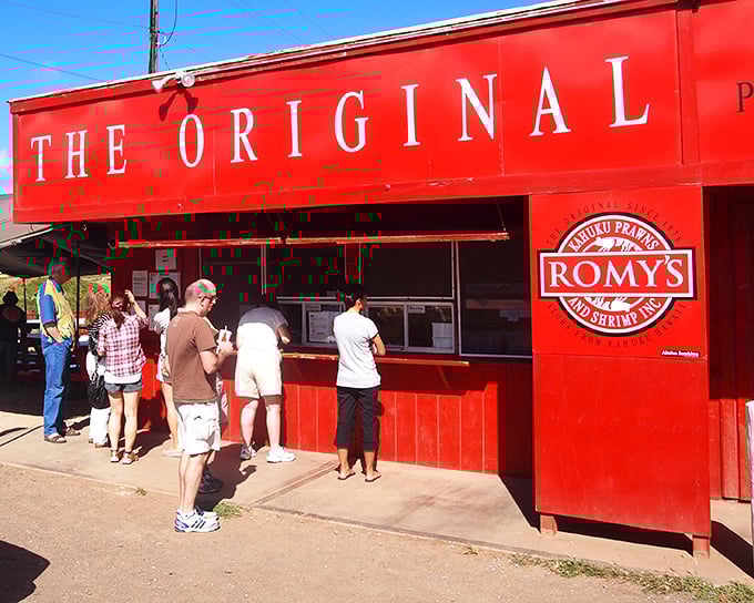 The iconic bright red shack of Romy's stands out like a culinary lighthouse, guiding hungry pilgrims to shrimp nirvana on Oahu's North Shore.