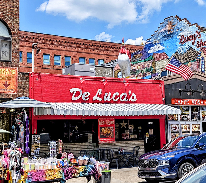 The iconic red facade of DeLuca's with its rooftop chicken statue stands out in Pittsburgh's Strip District like a breakfast lighthouse guiding hungry souls home.