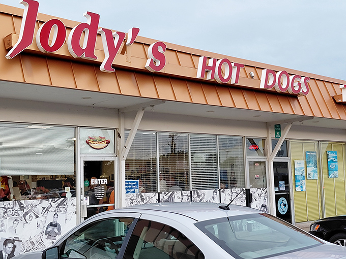 The iconic red lettering of Jody's Hot Dogs stands out against the Joliet sky like a beacon for hungry travelers seeking hot dog nirvana.