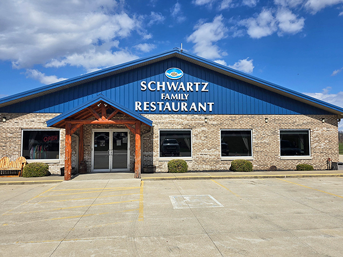 The blue-roofed beacon of comfort food stands proudly against Indiana skies, promising homestyle salvation for hungry travelers.