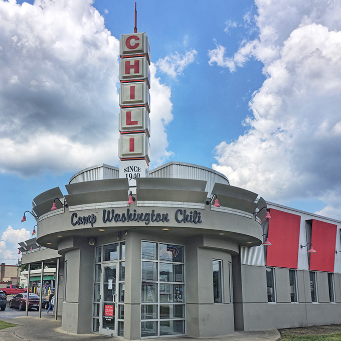 The iconic Camp Washington Chili sign reaches skyward like a delicious beacon, promising spiced salvation to hungry travelers at any hour.