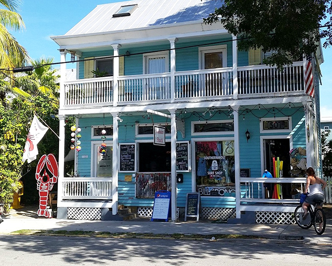 The classic Key West architecture of The Lobster Shack beckons like a siren song, its seafoam-green exterior promising seafood treasures within.