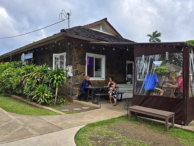 Lush greenery frames this unassuming seafood sanctuary where locals gather for what might be Kauai's most honest meal.