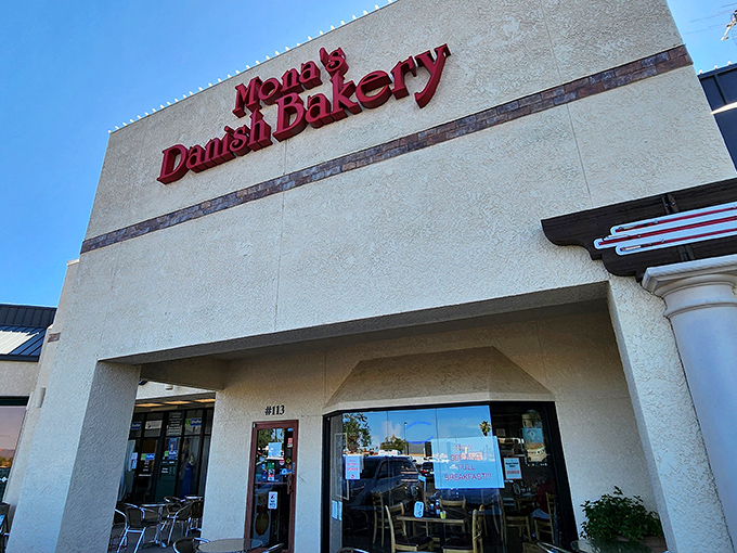 The bold red lettering against the cream-colored exterior isn't just signage&mdash;it's a beacon of hope for carb enthusiasts seeking Danish delights in the Arizona desert.
