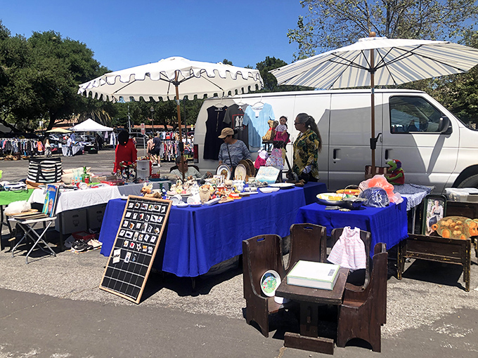 Vintage furniture meets whimsical umbrellas in this delightful chaos of commerce and community spirit.
