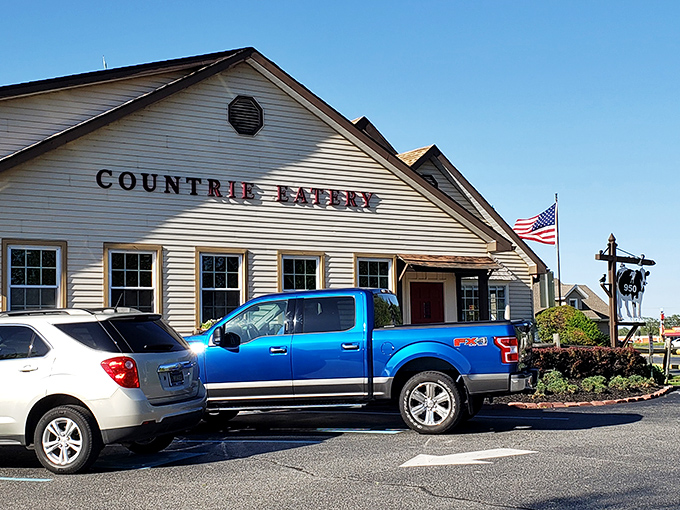 The classic cream-colored exterior of The Countrie Eatery stands proudly against a blue Delaware sky, promising comfort food and zero pretension.