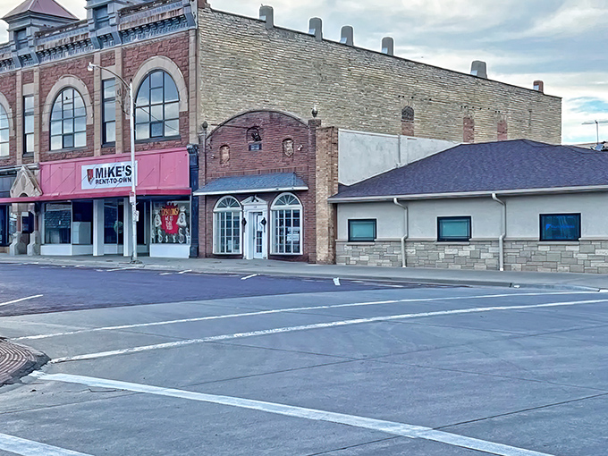 Historic brick buildings line Beloit's Main Street, where Mike's Rent-to-Own stands as a testament to the town's practical approach to life and affordability.