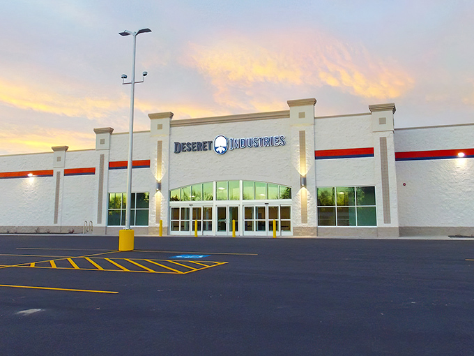 The Deseret Industries building glows at sunset like a beacon for bargain hunters, promising treasures inside that big box stores can only dream about.
