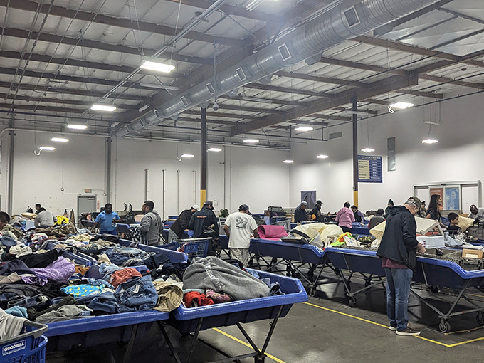 Welcome to the wild west of thrifting. Inside this warehouse, shoppers navigate blue bins like prospectors panning for retail gold.