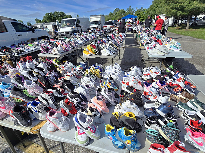 Sneaker heaven awaits! Tables stretching to the horizon showcase a rainbow of footwear where yesterday's limited editions become today's affordable treasures.