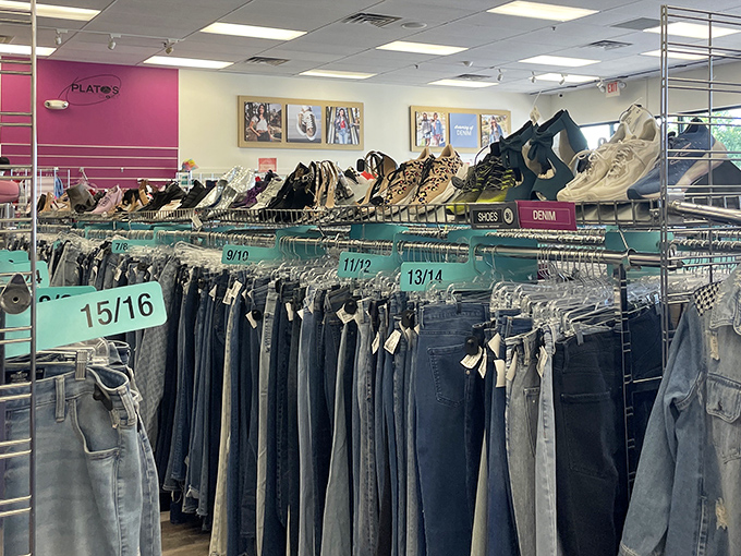 The denim paradise at Plato's Closet organizes jeans by size, creating a shopper's highway to fashion heaven without the usual thrift store treasure hunt.