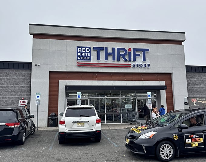 The unassuming exterior of Red White & Blue Thrift Store stands like a treasure chest waiting to be opened, promising bargain-hunting adventures under the bright New Jersey sky.