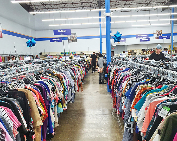 A sea of possibilities hangs in chromatic order, each rack a potential goldmine for fashion-forward penny pinchers.