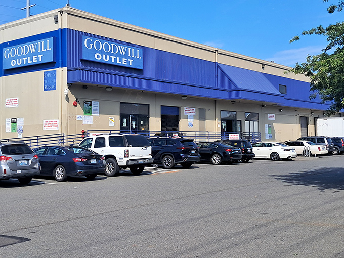 The blue-trimmed facade of Seattle Goodwill Outlet beckons bargain hunters like a siren call to sailors of savings.
