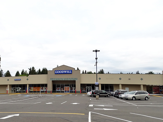 The Burien Goodwill stands like a treasure chest in the Pacific Northwest, its blue sign a beacon for bargain hunters and thrift enthusiasts alike.