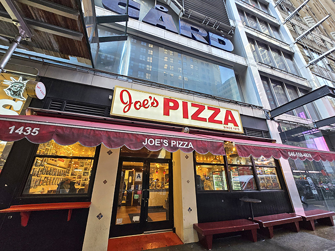 The pilgrimage begins! Joe's Pizza on Broadway draws crowds under its iconic red awning&mdash;a beacon of hope for the pizza-obsessed in Midtown Manhattan.