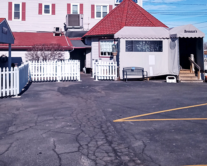 The unassuming exterior of Brennan's Fish House with its distinctive red-tiled roof proves that culinary treasures often hide in plain sight.