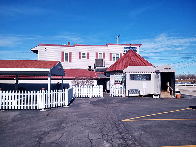The unassuming exterior of Brennan's Fish House stands like a culinary lighthouse on River Street, promising seafood treasures within its modest white walls.