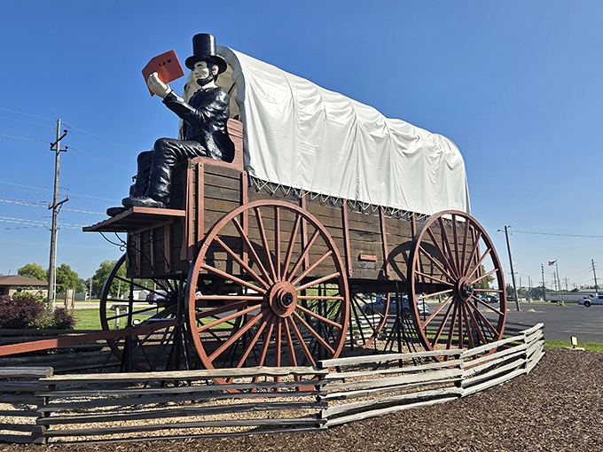 The World's Largest Railsplitter Covered Wagon stands proudly against the Illinois sky, proving that "go big or go home" isn't just a saying&mdash;it's a roadside attraction philosophy.