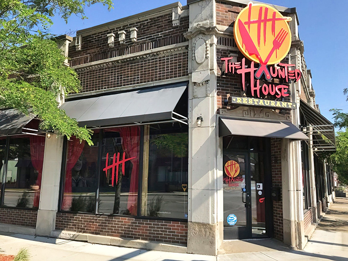The corner brick building with its bright red logo beckons like a friendly monster under the streetlight. Horror never looked so inviting!