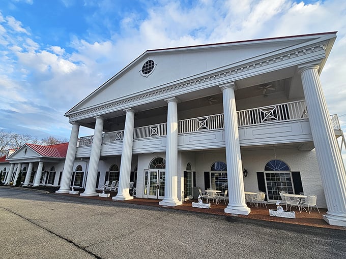 The grand colonial facade of Claudia Sanders Dinner House stands like a Southern palace dedicated to the worship of perfect fried chicken.