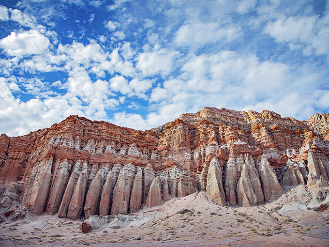 Nature's own cathedral rises from the desert floor, with columns that would make any architect jealous. The sky's just showing off at this point.