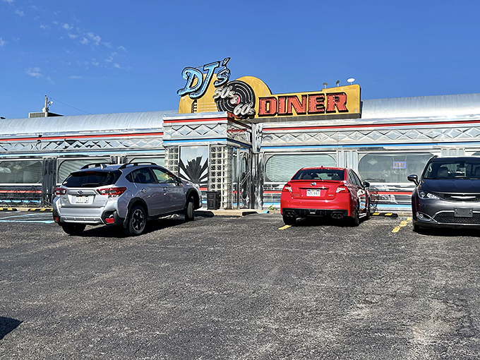 The gleaming chrome exterior of DJ's 50's & 60's Diner shines like a time machine, beckoning hungry travelers with promises of nostalgic delights inside.