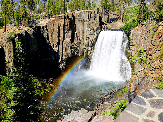Nature's special effects department outdid itself here &ndash; Rainbow Falls lives up to its name with that perfect arc of color against rugged volcanic cliffs.