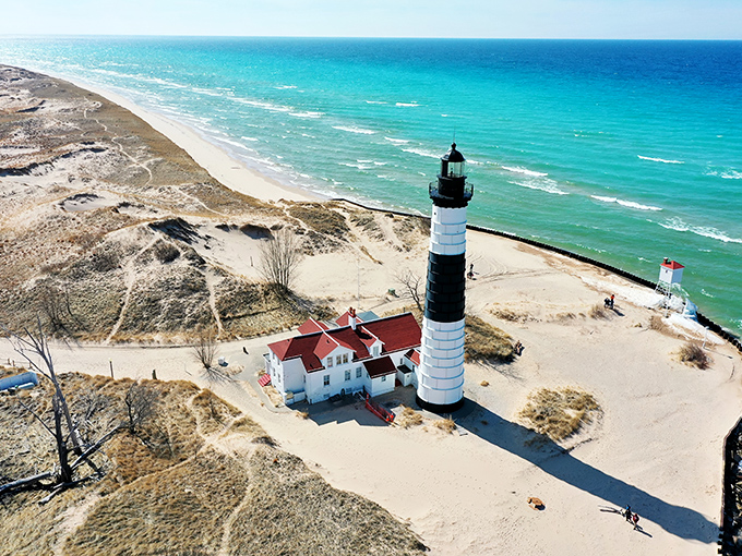 The black and white stripes of Big Sable Point Lighthouse stand in dramatic contrast against Michigan's turquoise waters, like nature's perfect color scheme.