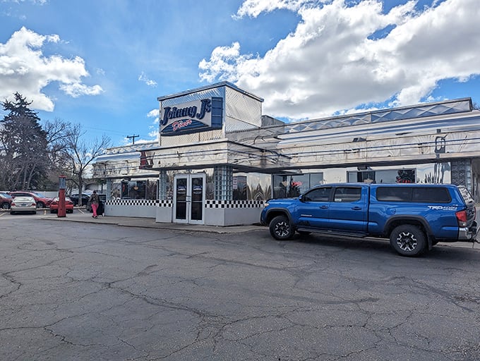 The gleaming chrome exterior of Johnny J's stands like a time machine in Casper, beckoning hungry travelers with its classic blue signage and checkerboard trim.