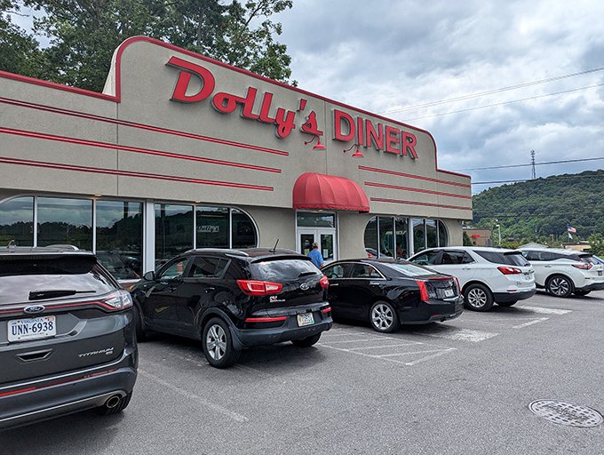 Dolly's Diner stands proudly against the West Virginia mountains, its red signage promising comfort food salvation for hungry travelers and locals alike.