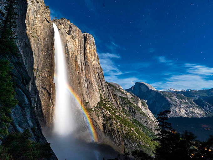 Nature's ultimate light show: Yosemite Falls creates its own rainbow against granite cliffs, proving Mother Nature was the original Instagram influencer.