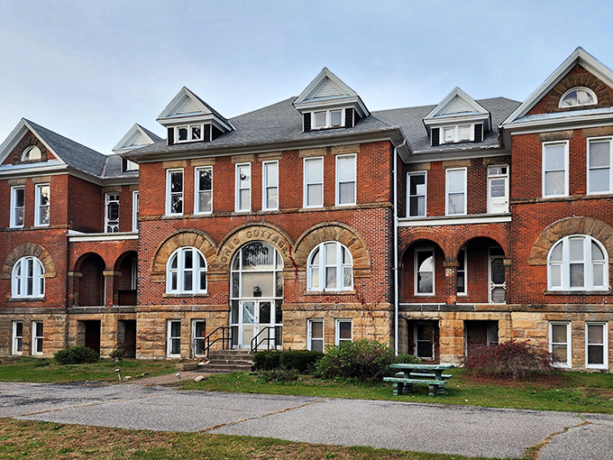Red brick and stone arches frame the "Old Cottage" entrance, where countless souls once passed through, some perhaps never to return to the outside world.