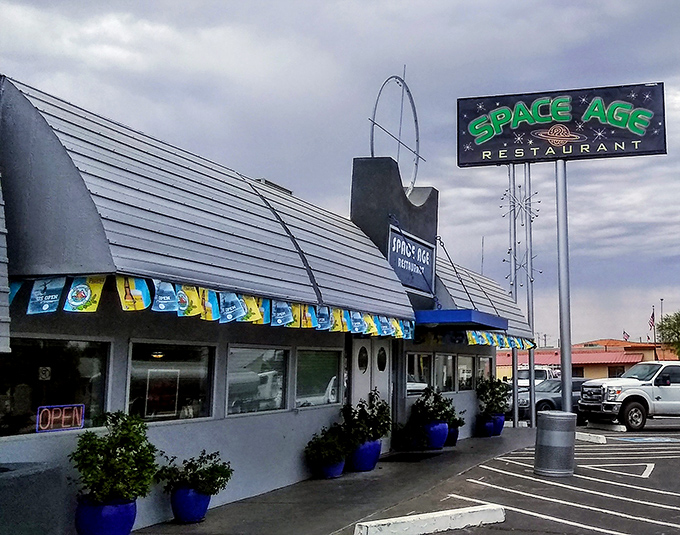 The Space Age Restaurant's iconic silver roof gleams against the Arizona sky like a UFO that decided the hash browns were worth staying for.