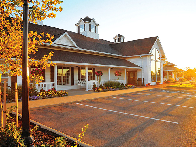 Bathed in golden sunset light, Berlin Farmstead's welcoming facade promises comfort before you even reach the door. Rocking chairs await your post-meal contemplation.