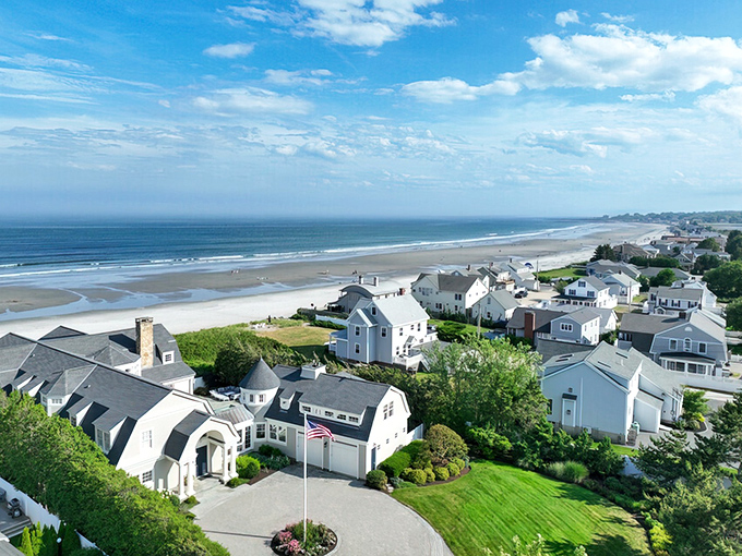 The shoreline of Rye Beach stretches gracefully, with charming houses lining the coast where the Atlantic meets New Hampshire's scenic paradise.