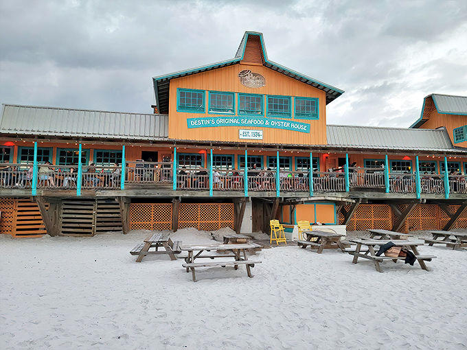 Beachfront paradise or seafood heaven? At Dewey Destin's, you don't have to choose. The weathered orange-brown exterior sits proudly on sugar-white sand, promising maritime delights within.