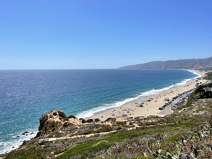 Point Dume's dramatic coastline stretches into the distance, where golden sands meet the Pacific's blue embrace&mdash;nature's own infinity pool with a California zip code.