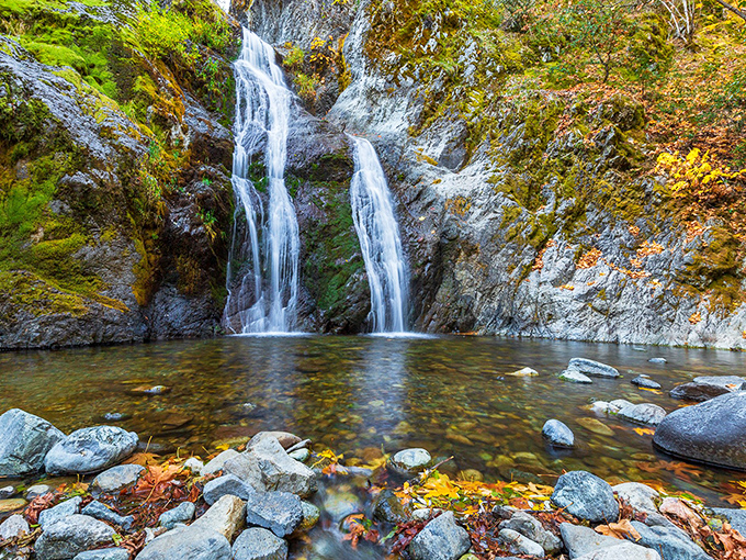 Nature's perfect cascade &ndash; Faery Falls tumbles 50 feet over moss-covered rocks, creating a crystal-clear pool that practically begs for a brave toe-dip.