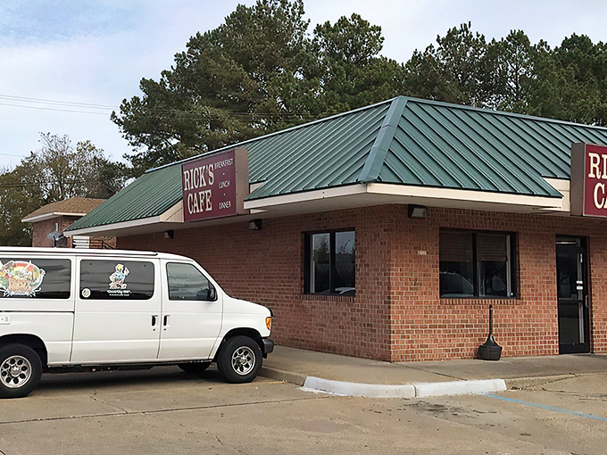 The unassuming exterior of Rick's Cafe, with its distinctive green roof, proves once again that culinary treasures often hide in plain sight.