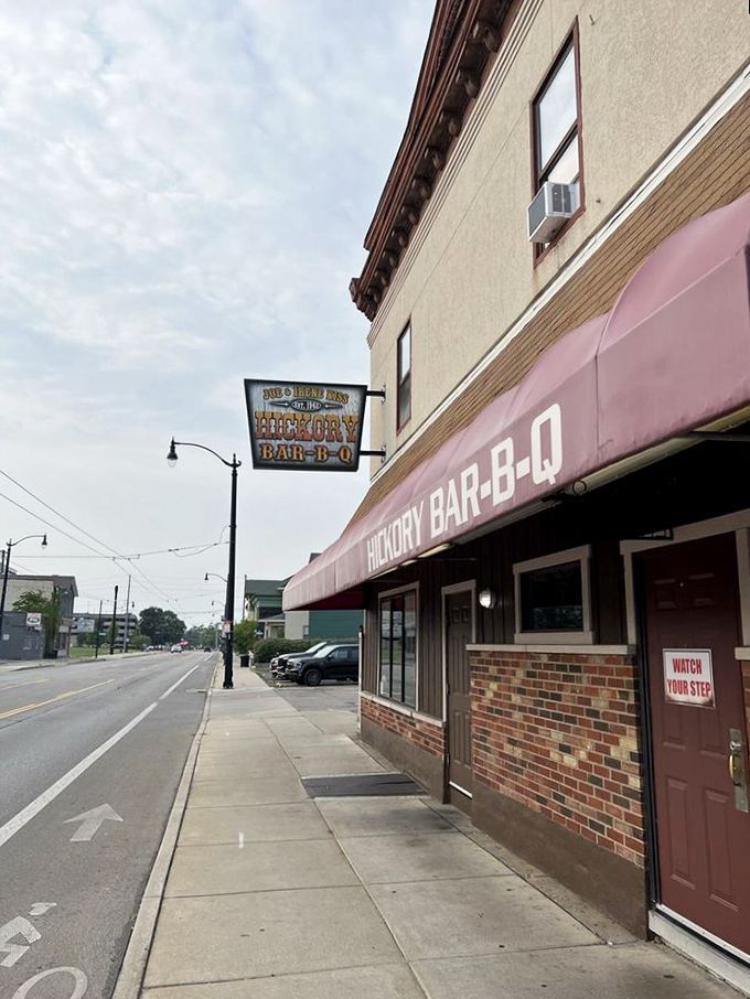 The burgundy awning of Hickory Bar-B-Q stands like a beacon of smoky promise on this Dayton corner, where culinary magic has been happening since long before food bloggers existed.
