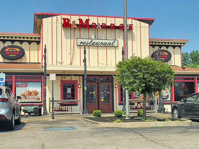 The cream and red facade of B & M Bar B Que stands like a beacon to hungry travelers. No fancy frills, just the promise of smoky perfection within.