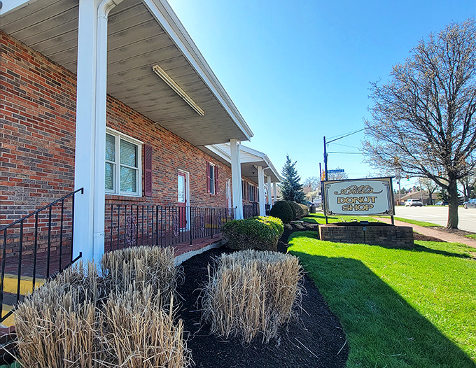 The brick exterior of Bill&rsquo;s Donut Shop stands like a temple to fried dough, its classic sign promising sugary salvation and comfort in every perfectly glazed bite.