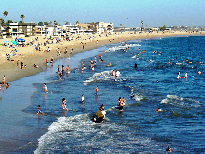 Sun-seekers find their paradise along Seal Beach's welcoming shoreline, where the waves are gentle enough for everyone from toddlers to grandparents.
