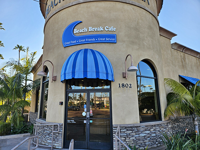 The iconic blue awning of Beach Break Cafe beckons like a lighthouse for hungry souls. This corner of coastal paradise has saved many a morning.