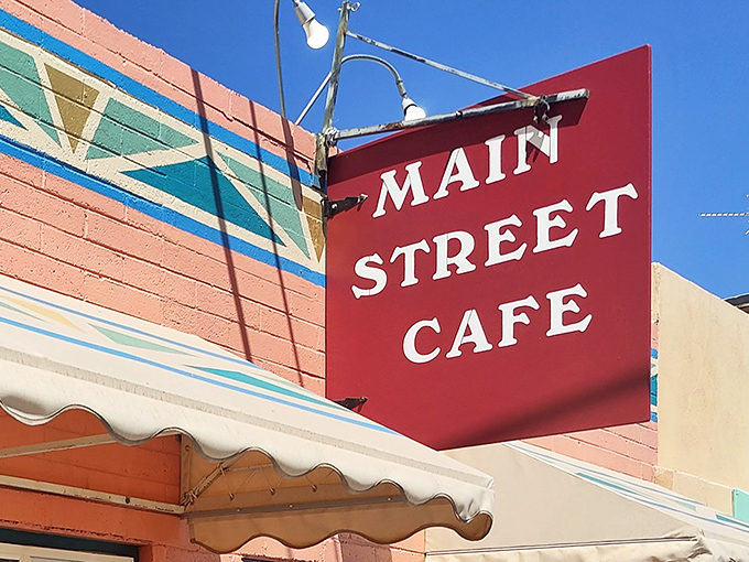 The iconic red sign of Main Street Cafe stands out against the colorful exterior, like a beacon calling hungry travelers home to Hurricane.