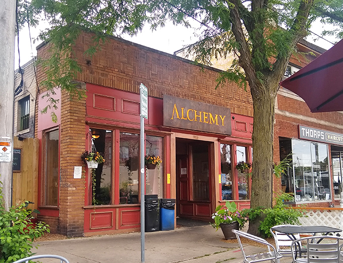 The brick-and-burgundy facade of Alchemy Cafe stands like a culinary beacon on Atwood Avenue, promising delicious alchemy within.